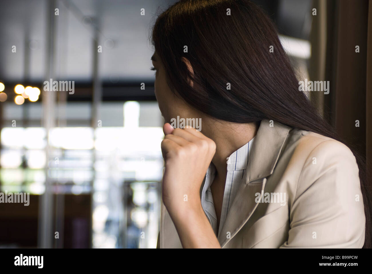 Young woman in a restaurant, looking over shoulder toward door Stock ...
