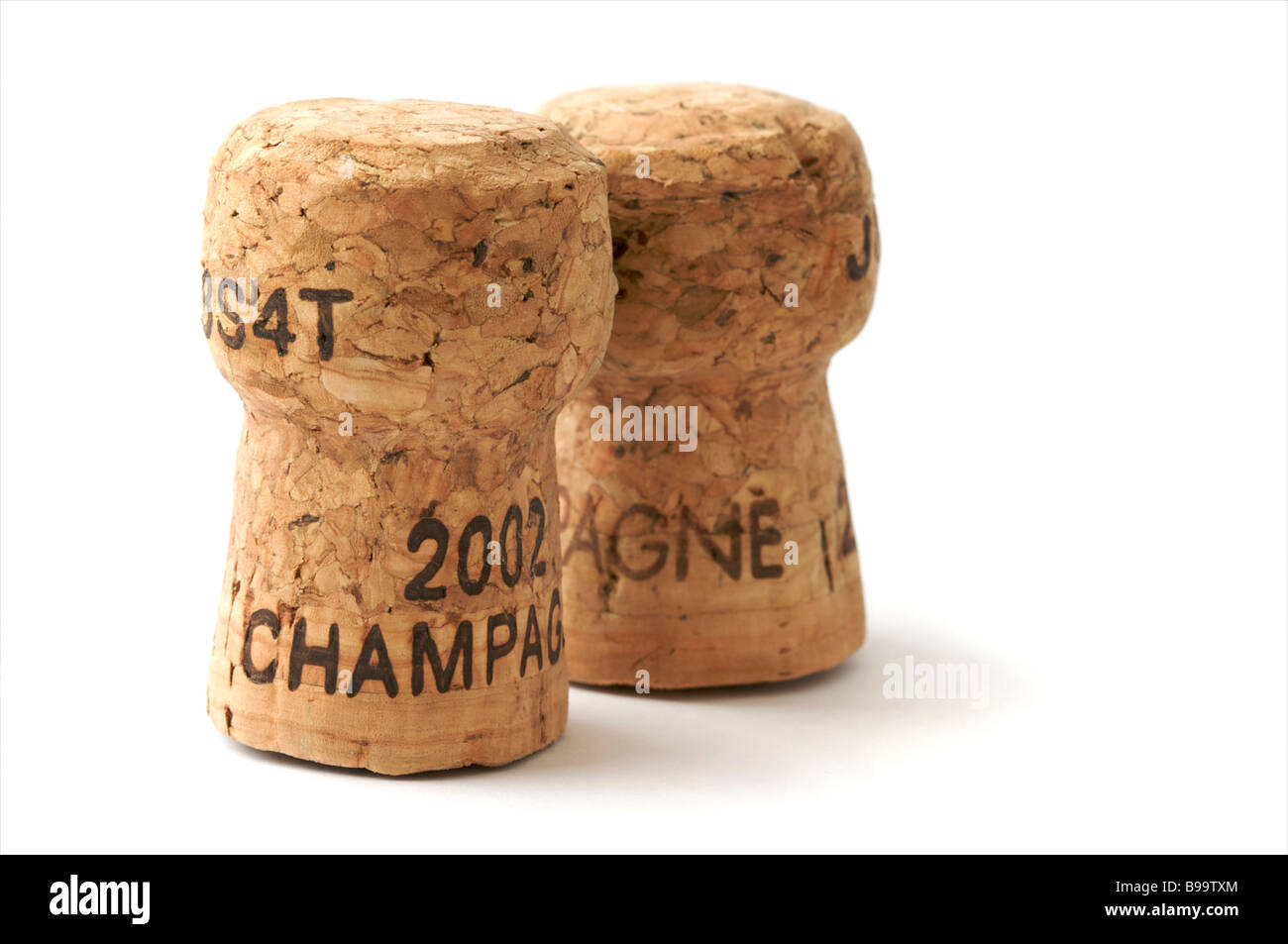 Two champagne corks isolated on a white background Stock Photo - Alamy