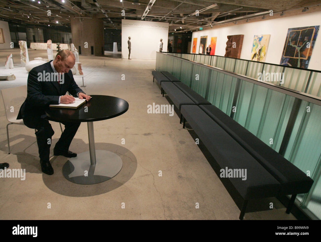 Russian President Vladimir Putin signs Visitors Book at an exhibition ...