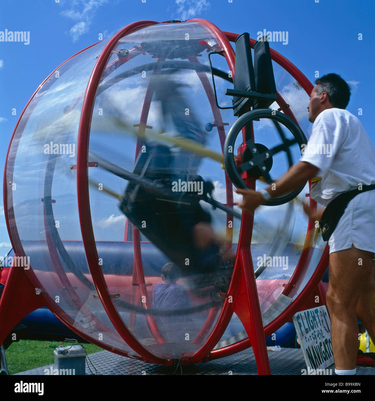 Flight simulation machine. Operator spinning a person in a vintage ...