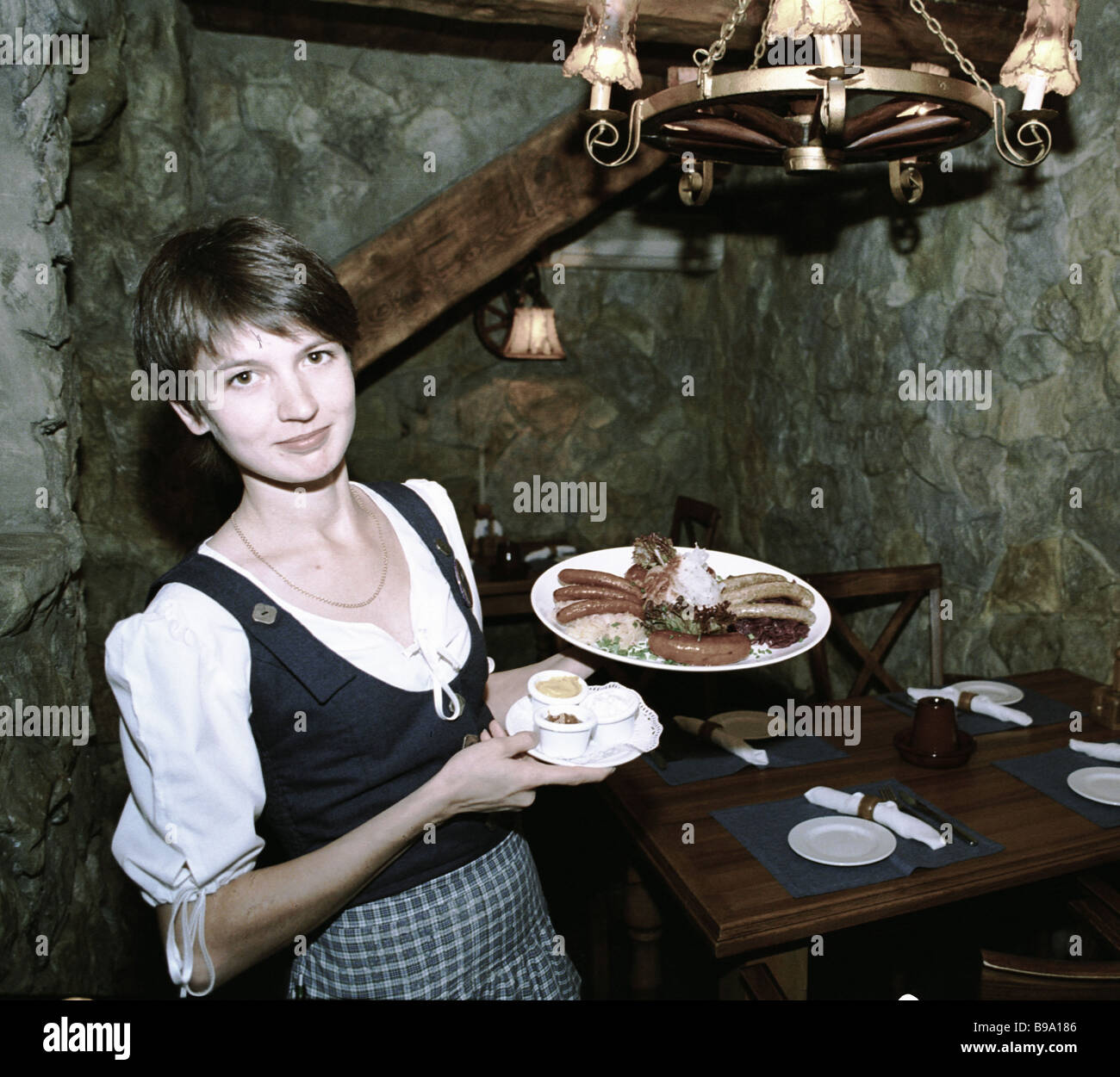 A waitress carrying orders to the tables in the Bavarius beerhouse ...