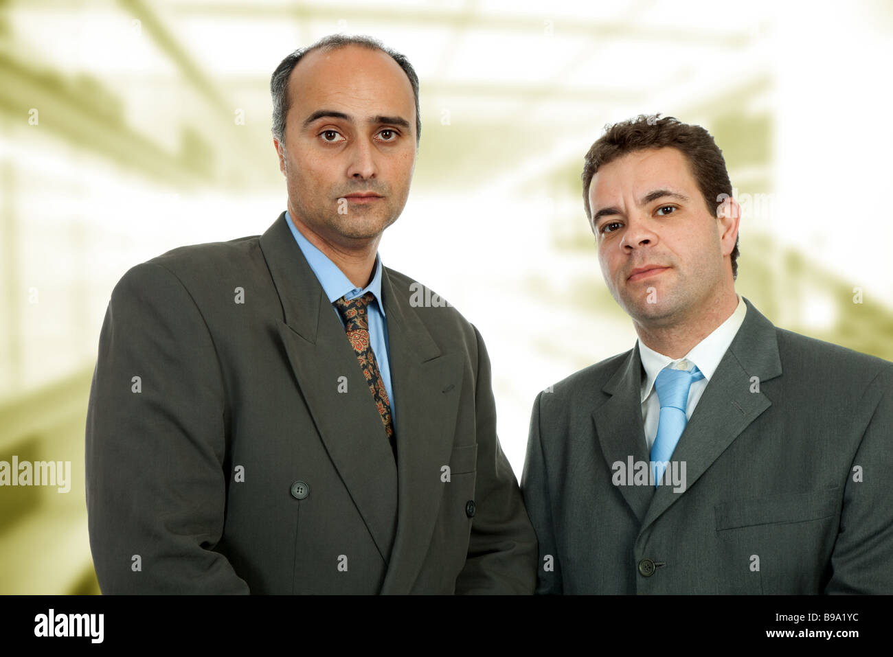 two business men portrait in a office building Stock Photo - Alamy