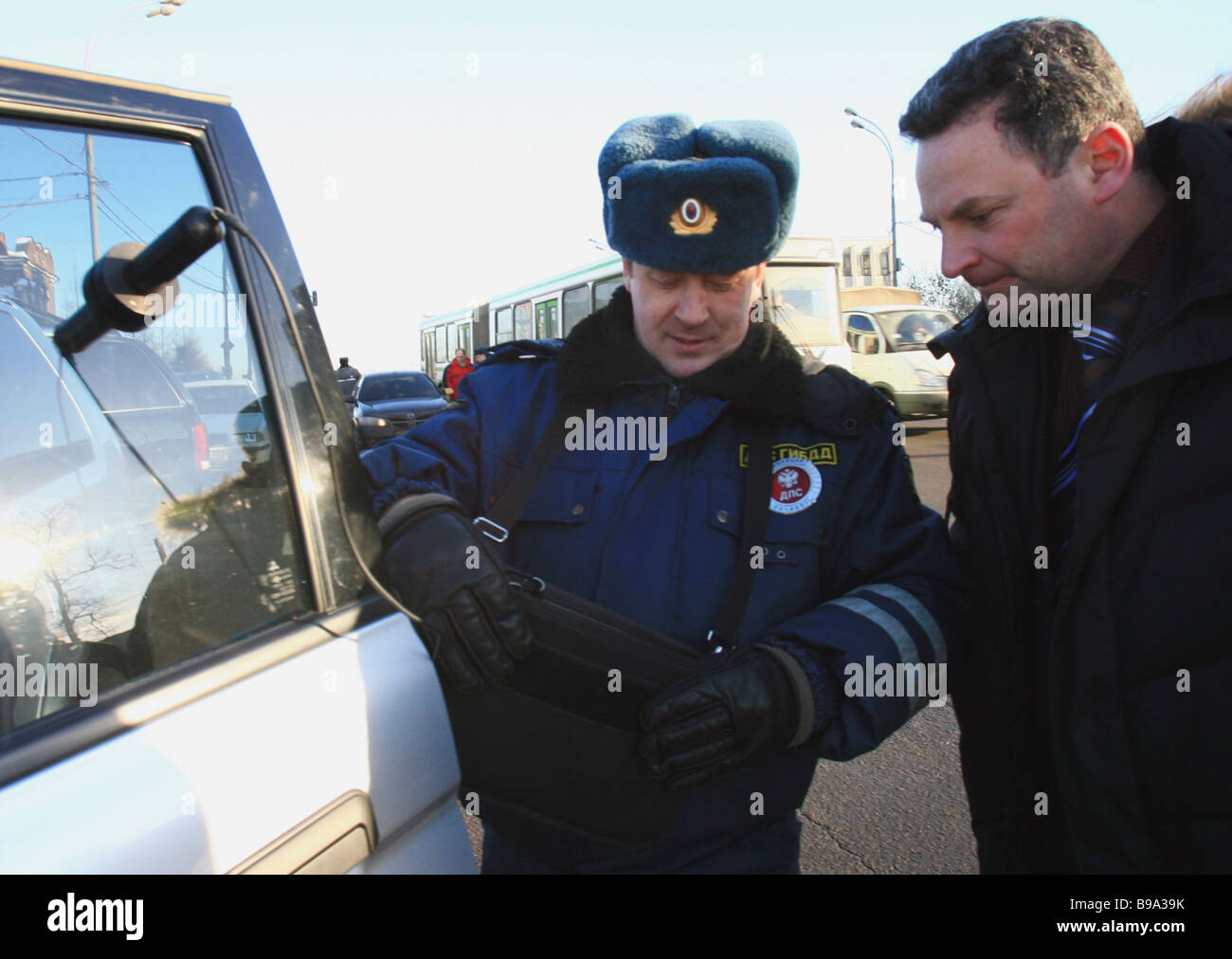 A traffic police inspector checking tinted car window transparency in ...