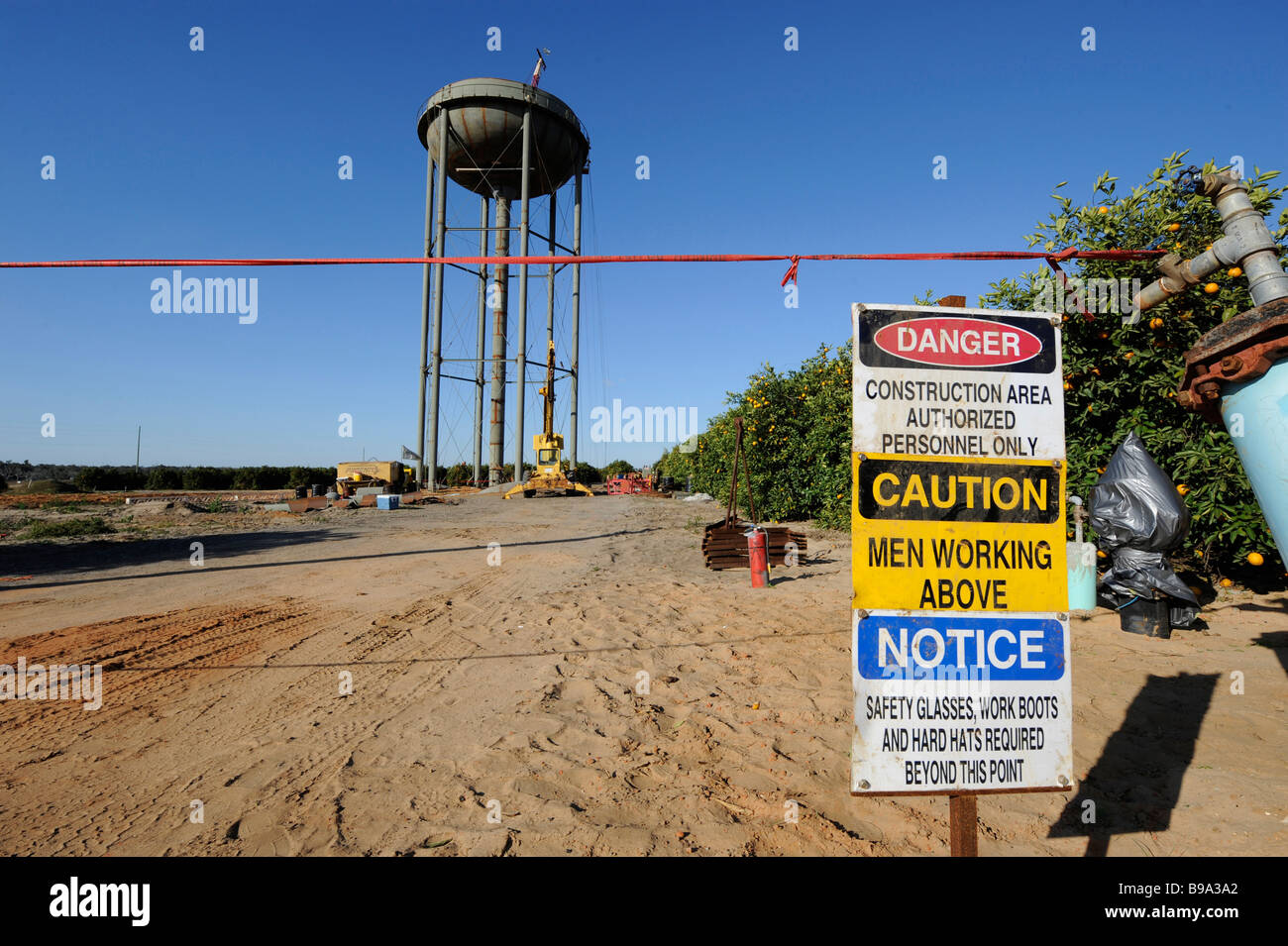 Water tower being built with warning hazard sign signs Stock Photo - Alamy