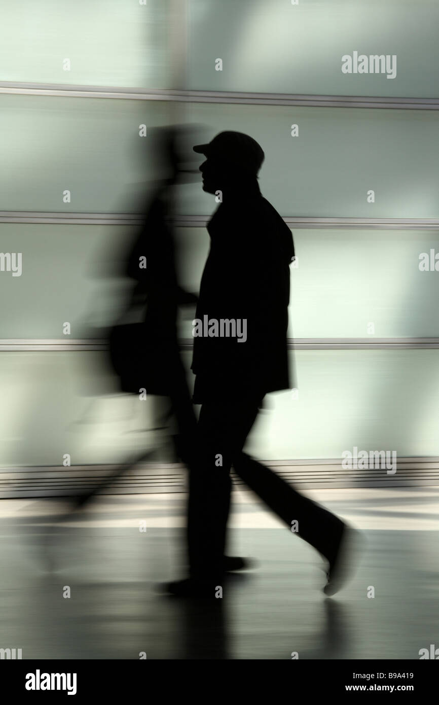 Silhouettes of two people passing by Stock Photo - Alamy