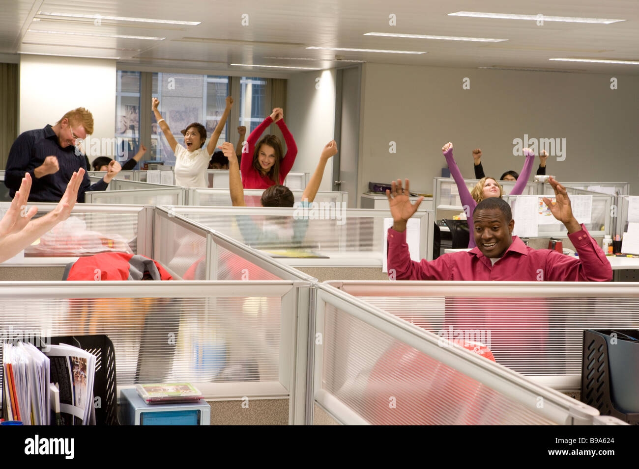 Co workers cheering in office Stock Photo - Alamy