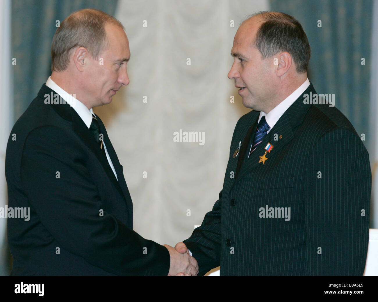 Russian President Vladimir Putin left confers title of Hero of the ...
