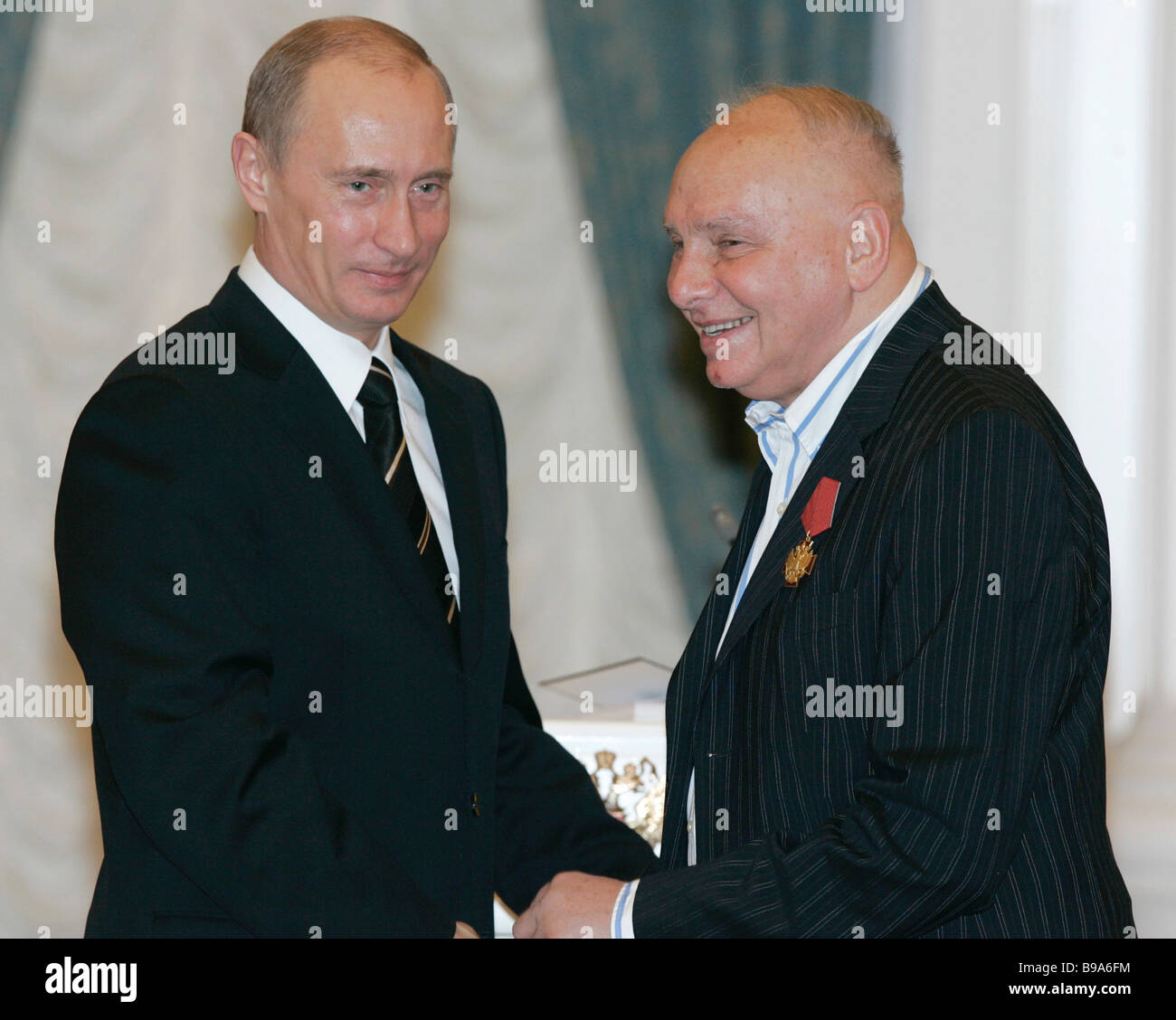 President Vladimir Putin left decorating Vitaly Wolf right the host of ...