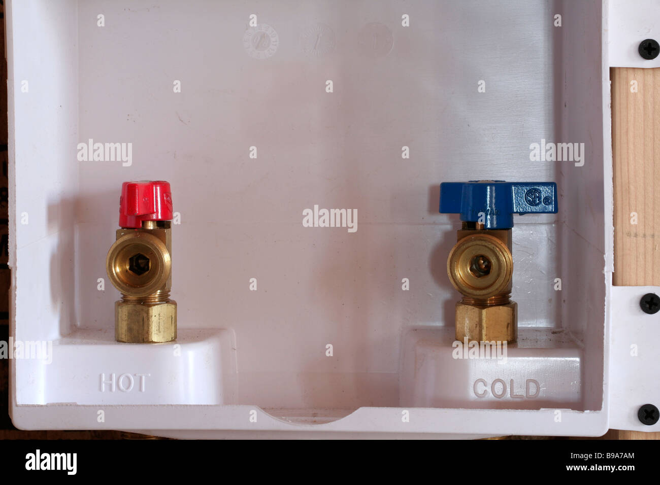 Hot and cold faucets in modern laundry room plumbing fixture Stock ...