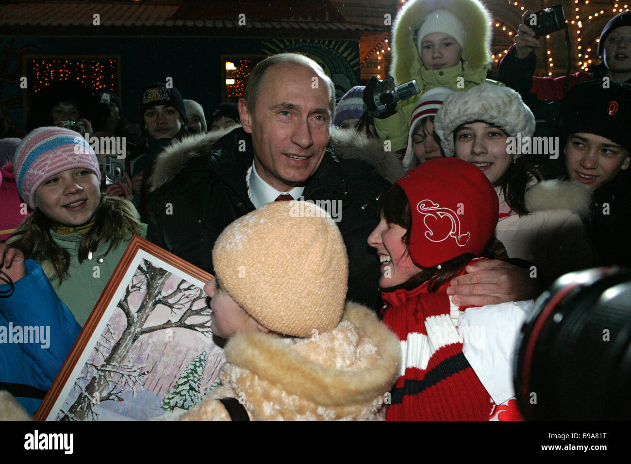 Russian President Vladimir Putin talks to children while visiting the ...