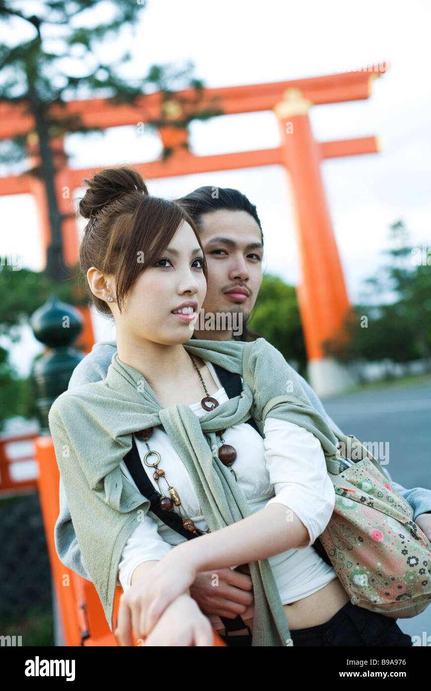 Young couple leaning against railing together, traditional Japanese ...
