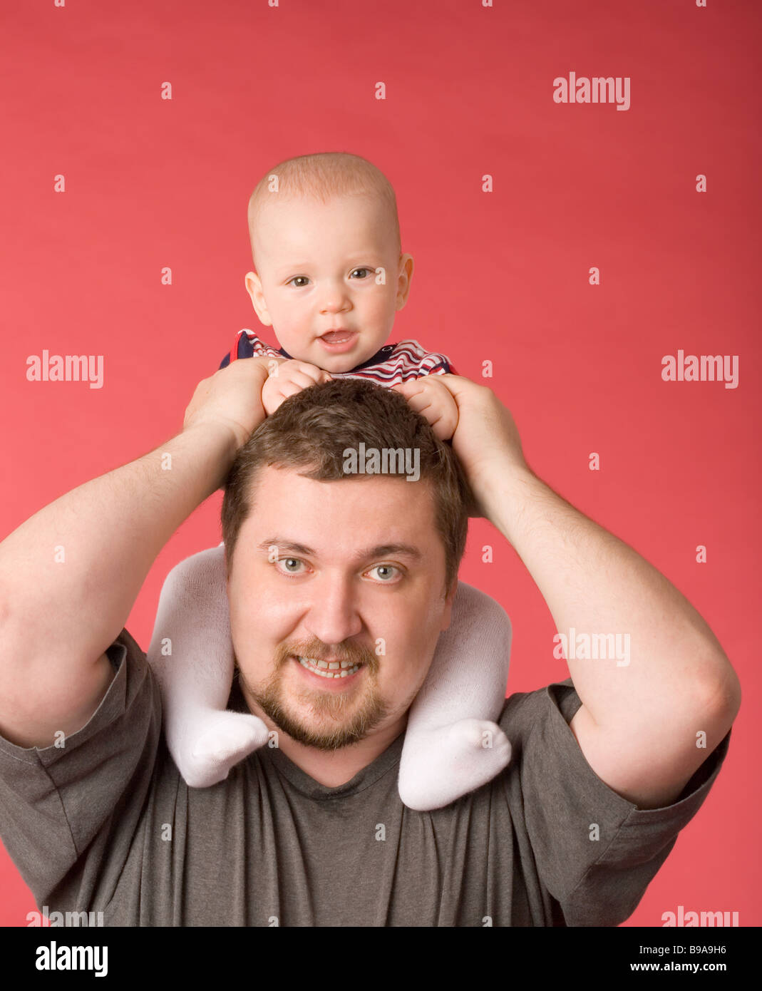 the father with son on red background Stock Photo - Alamy