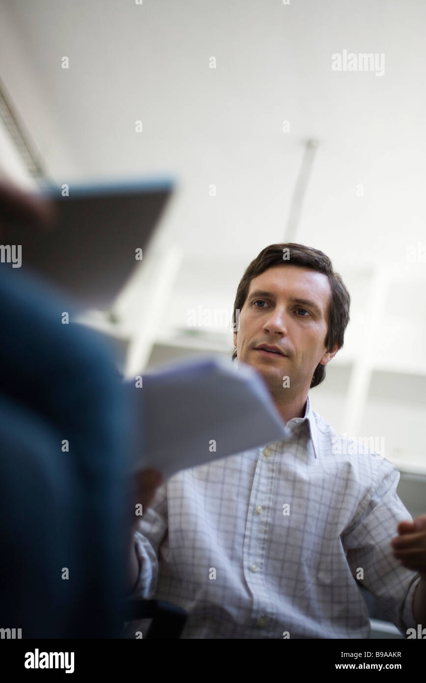 Men reviewing document Stock Photo - Alamy