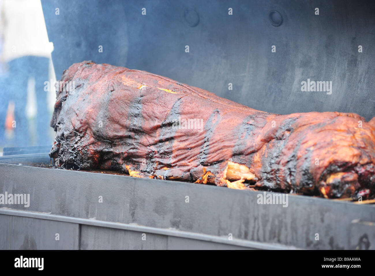 Pig roasting on an open grill Stock Photo - Alamy