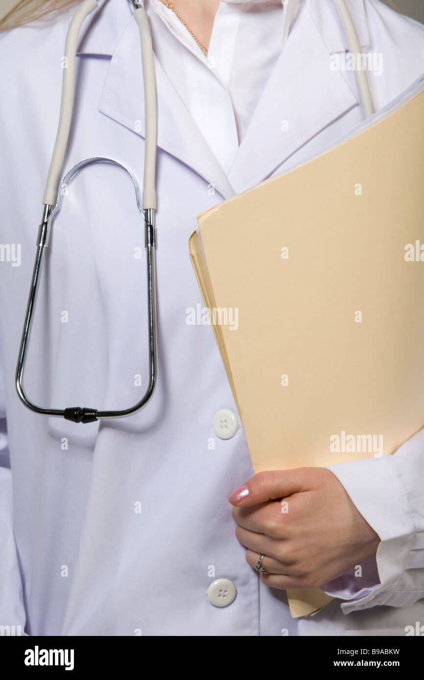Female doctor holding patient file Stock Photo - Alamy