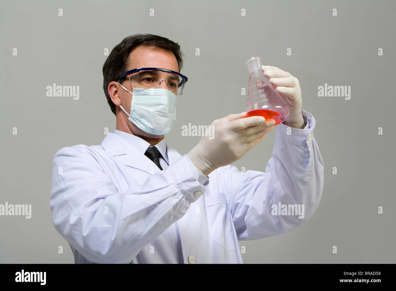 Scientist examining liquid in beaker Stock Photo - Alamy Scientist examining liquid in beaker Stock Photo - Alamy