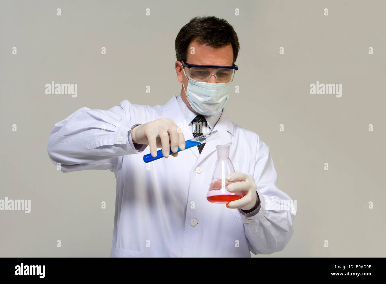 Scientist mixing liquids Stock Photo - Alamy