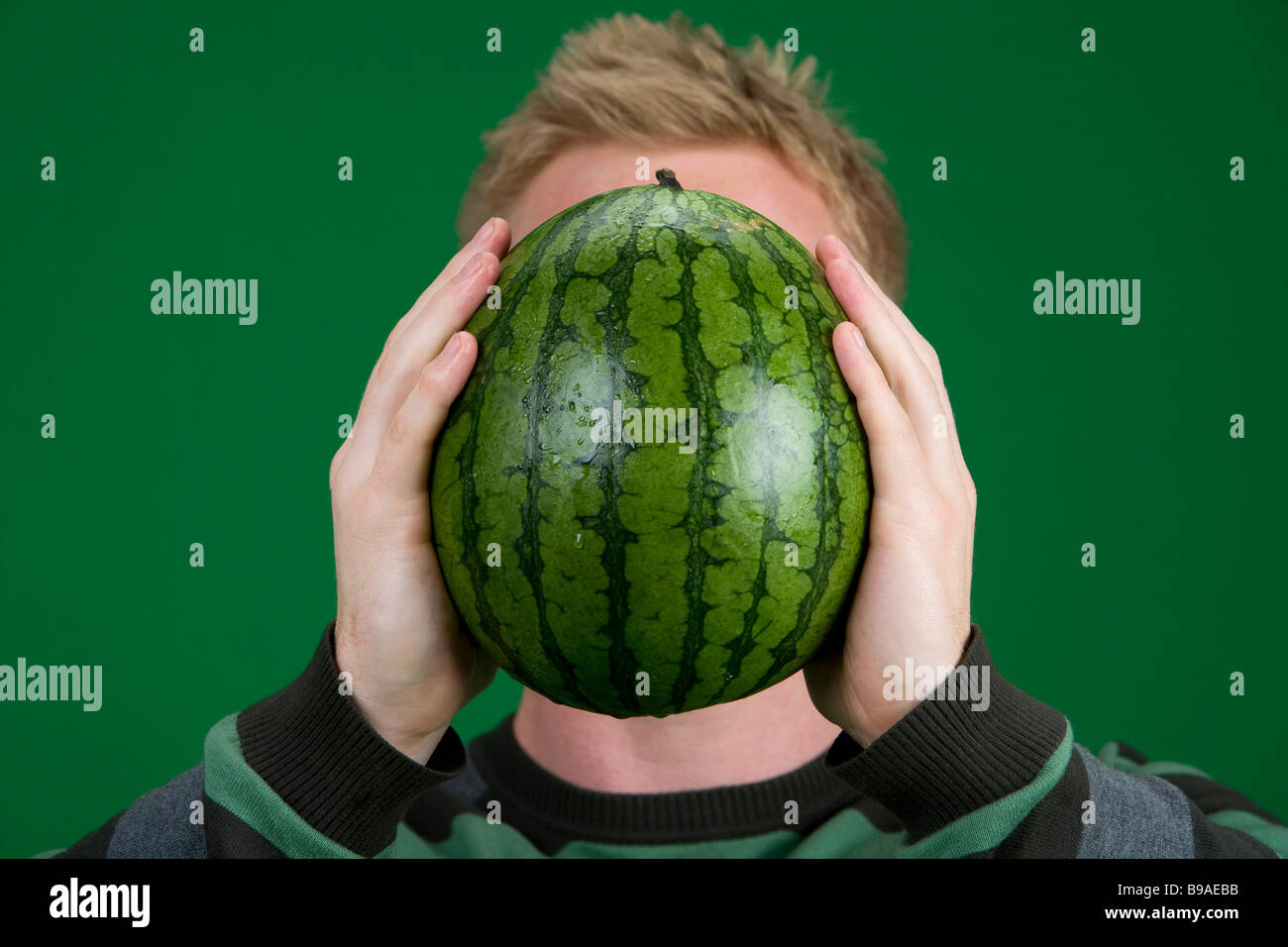 Man holding watermelon Stock Photo - Alamy