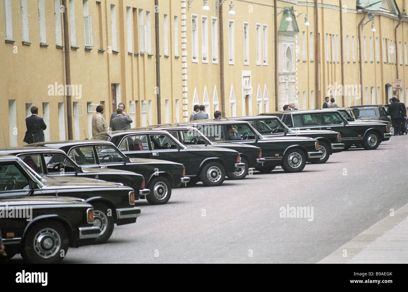 Office cars lining up down the street Stock Photo - Alamy