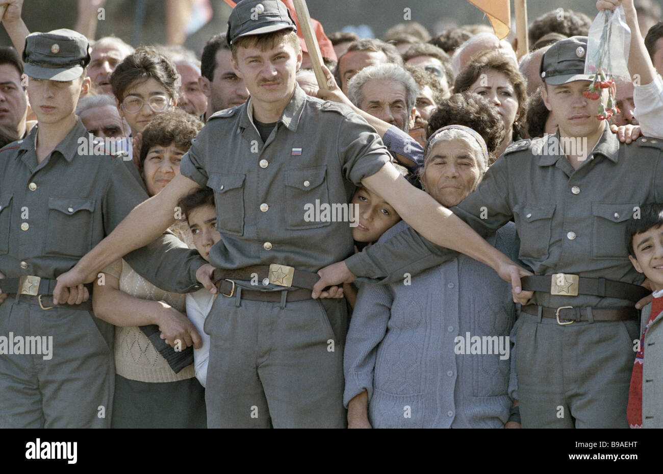 Russian servicemen holding back the crowd at a rally in Stepanakert ...