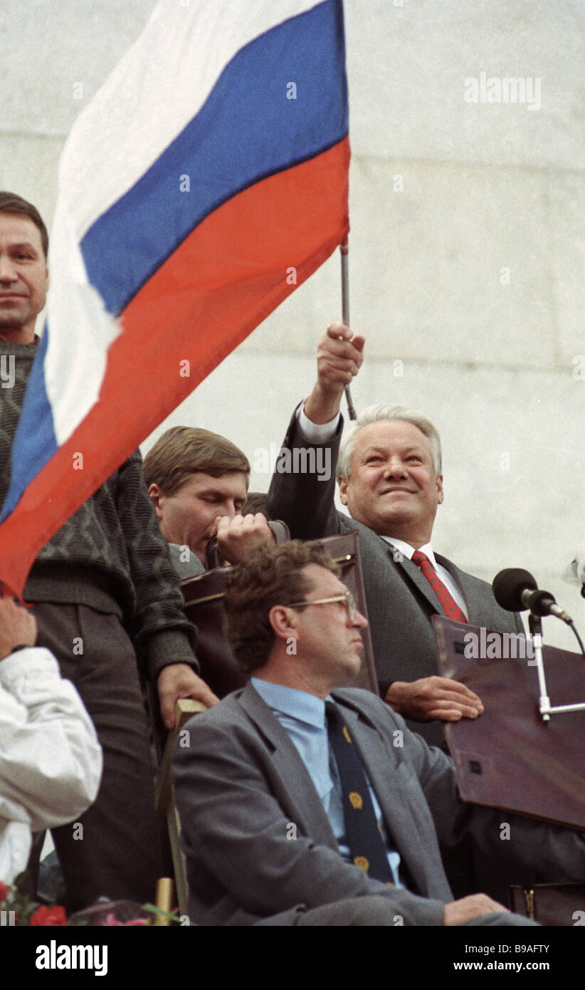 Russian President Boris Yeltsin standing on a rostrum with a flag in ...