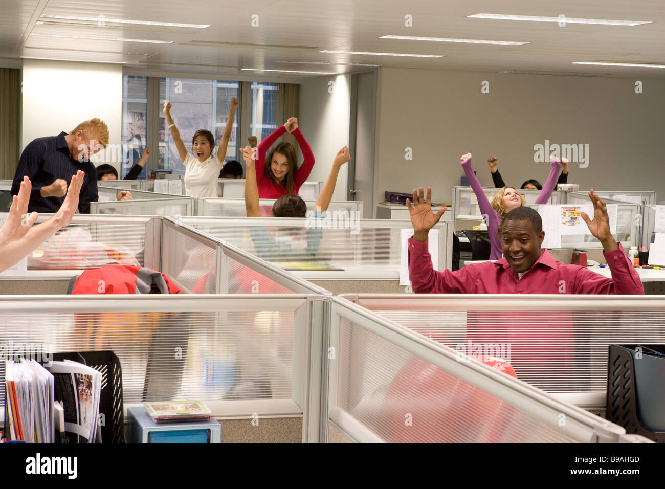 Co workers cheering in office Stock Photo - Alamy