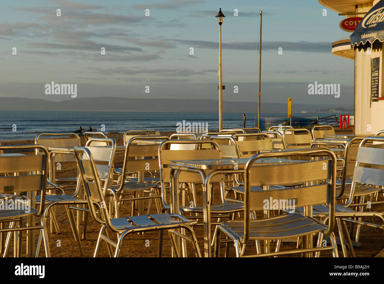 Beach front cafe with surfers in the distance Stock Photo - Alamy