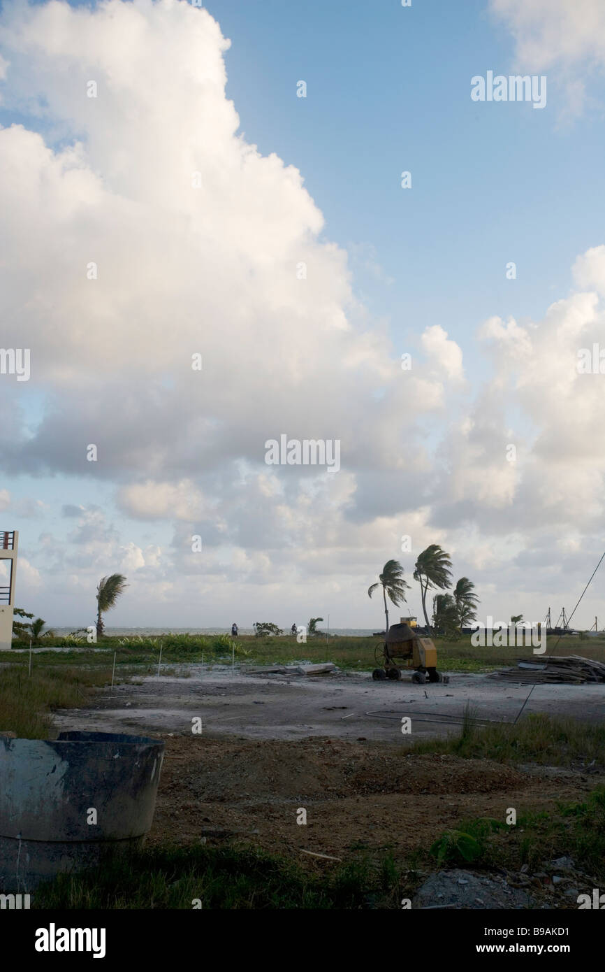 An empty residential lot with a cement mixer sit under late afternoon ...
