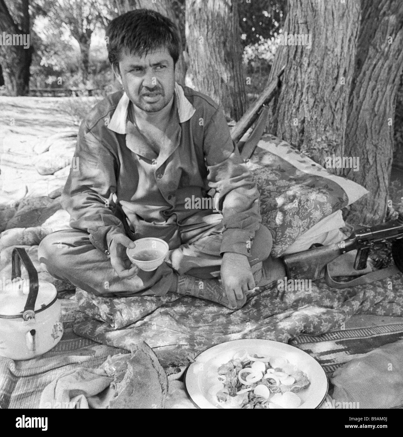 A militant from an armed group having lunch at his guard post Stock ...
