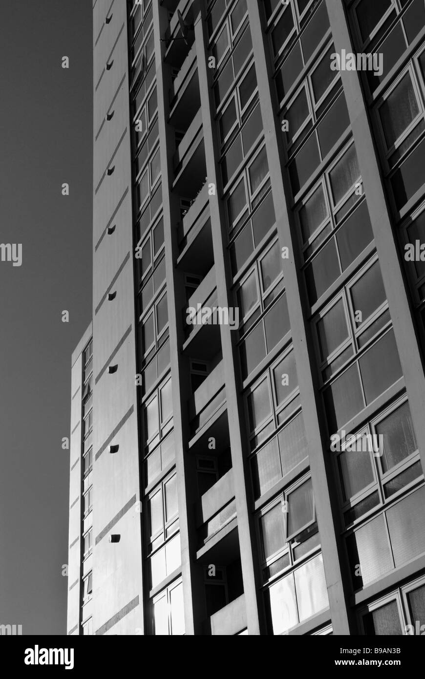 A 1960`s block of flats with sunlight reflecting off windows in ...