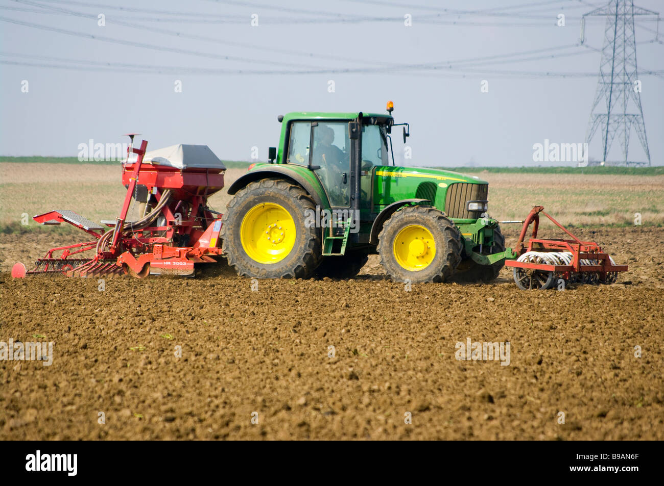 Farmer In His Tractor Preparing His Farm Field On The Isle of Grain In ...