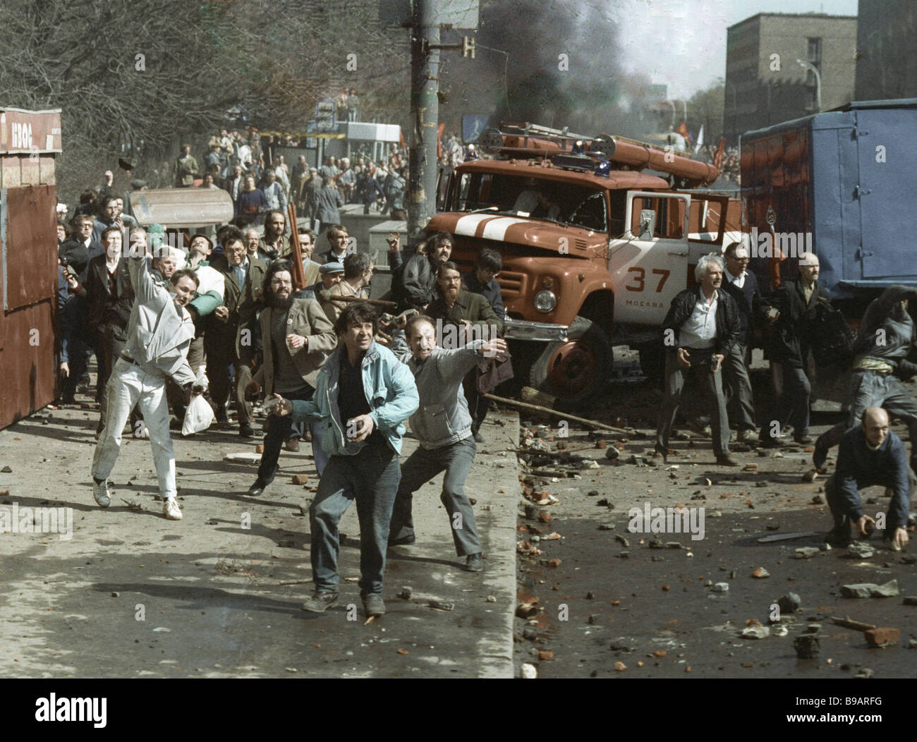 Demonstrators representing opposition forces throwing stones at OMON ...