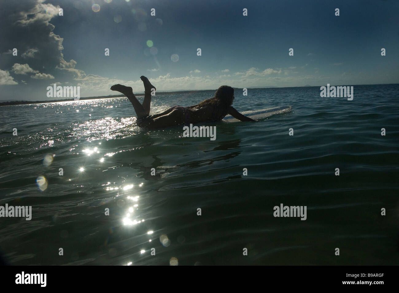 Surfer paddling out into the waves hi-res stock photography and images ...
