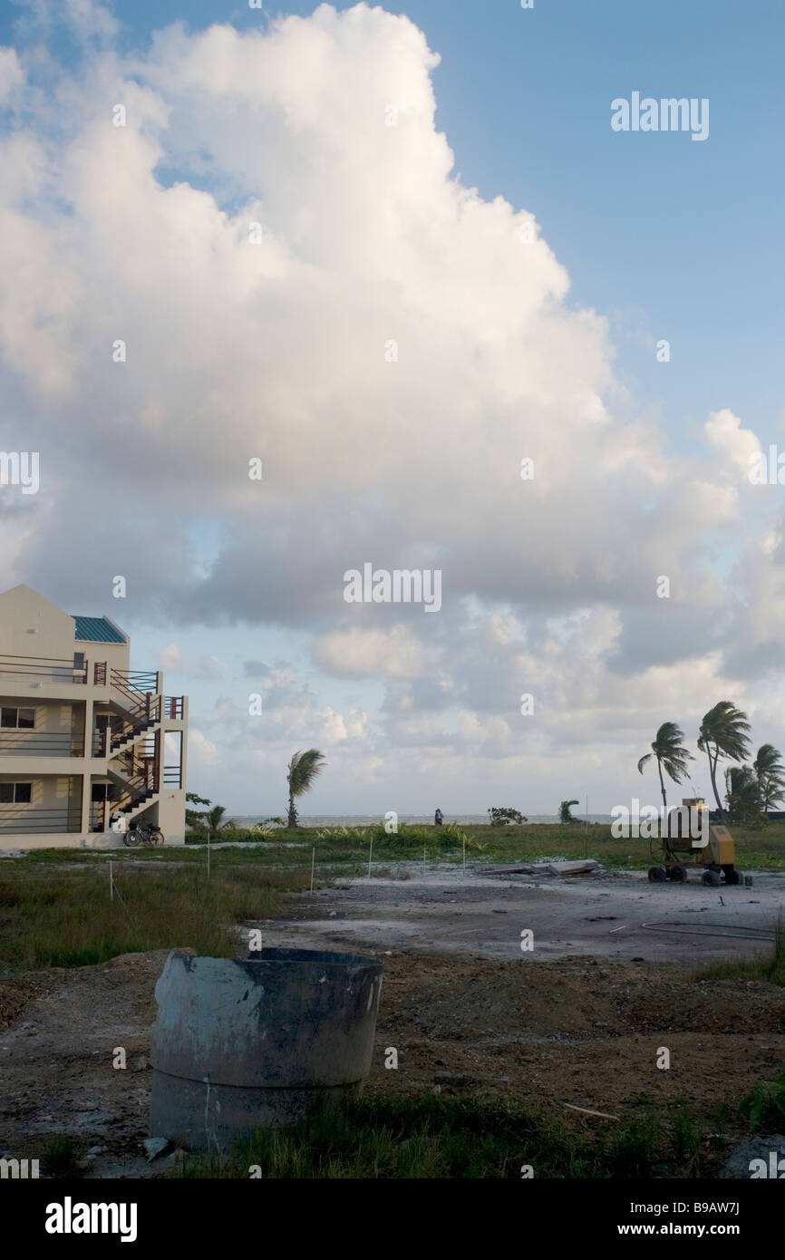 An empty residential lot with a cement mixer sit under late afternoon ...