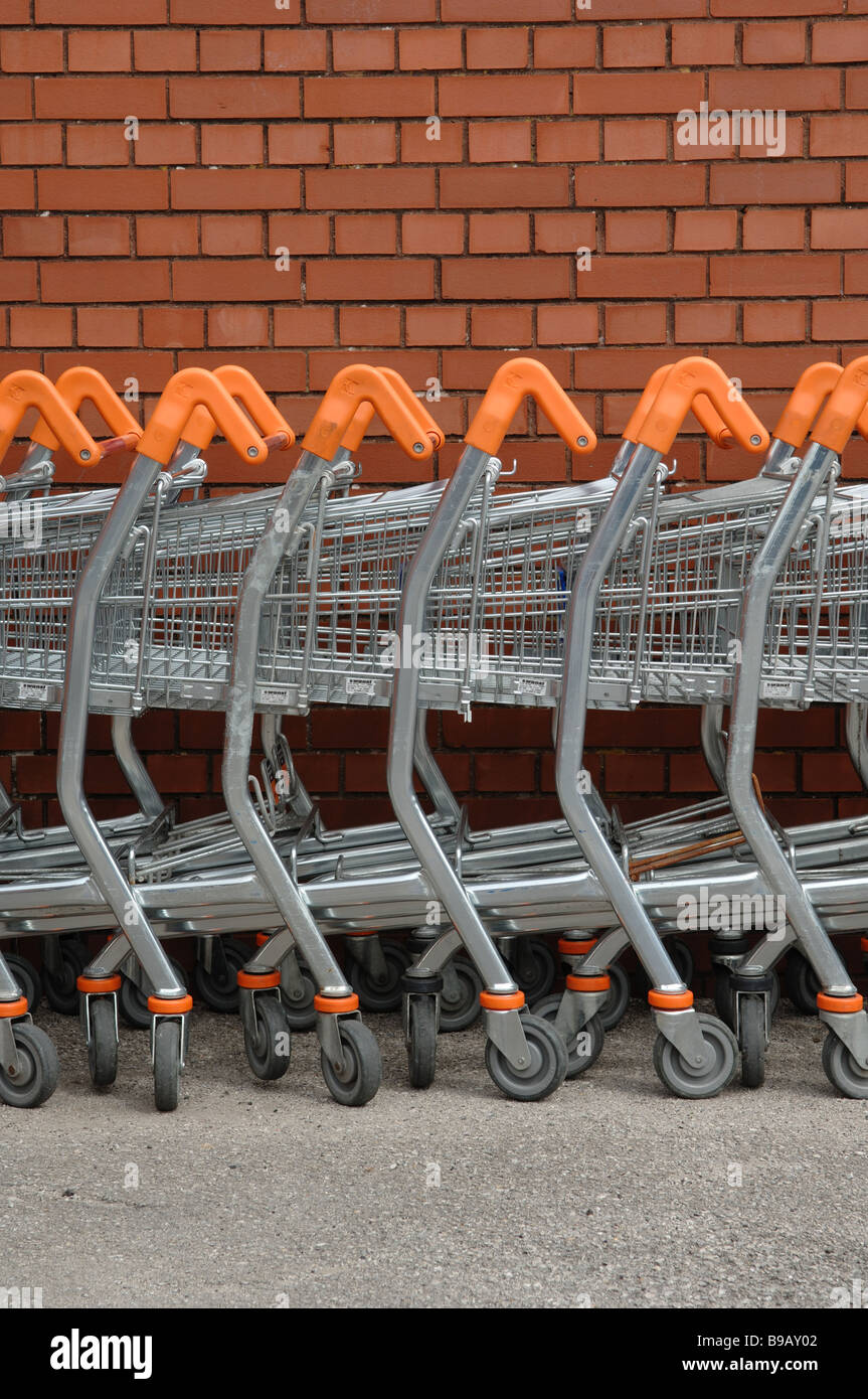 A row of supermarket shopping trolleys against a brick wall Stock Photo ...