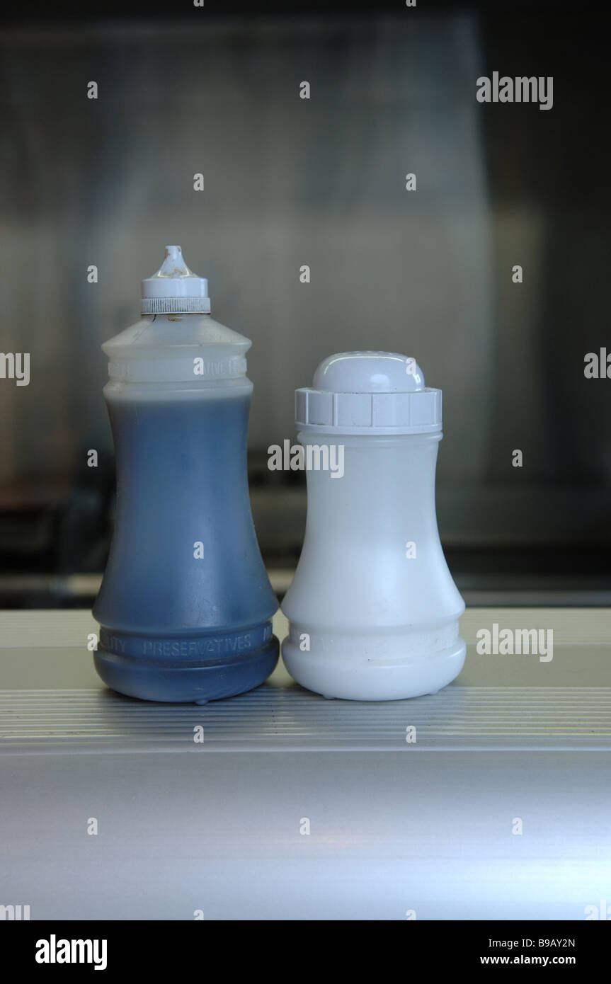 salt and vinegar on the counter of a food stall or cafe or chip shop ...