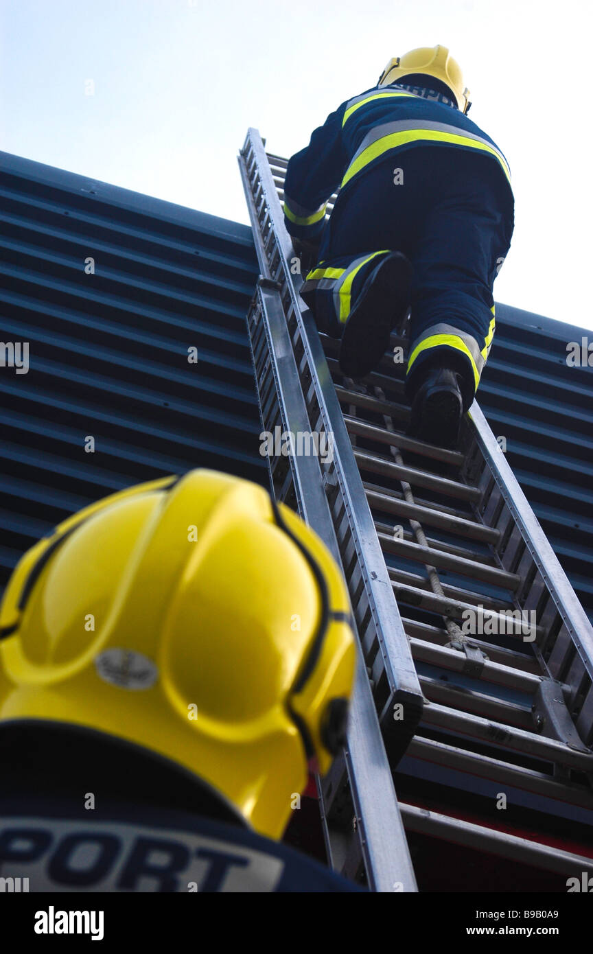 A firefighter climbing a ladder Stock Photo - Alamy