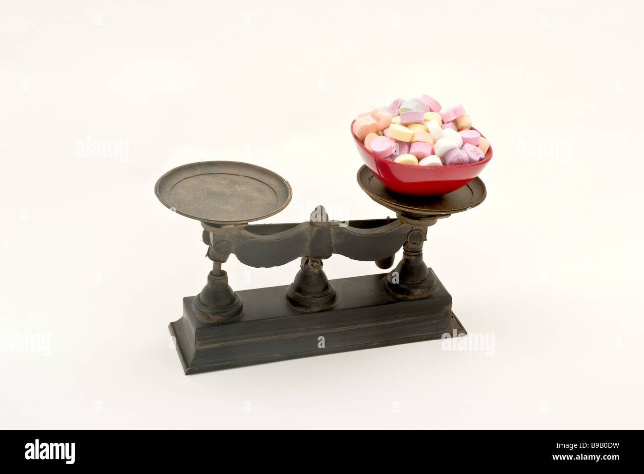 Candy dish on a balance scale filled with heart shaped hard candy Stock ...