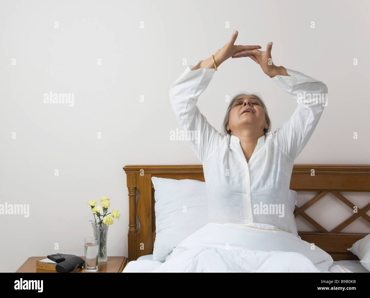 Woman stretching on the bed Stock Photo - Alamy