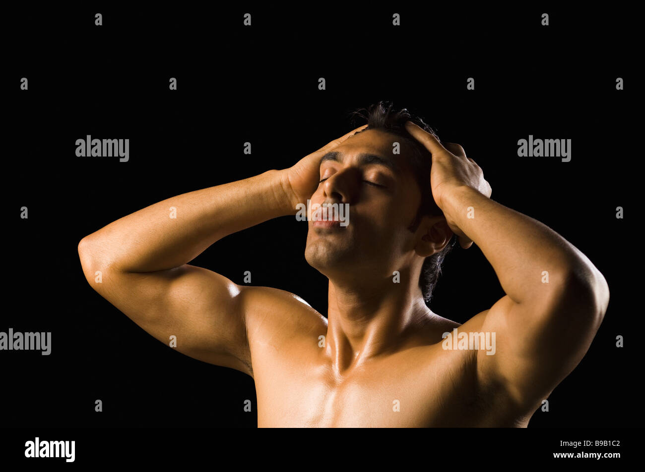 Close-up of a man holding his head Stock Photo - Alamy