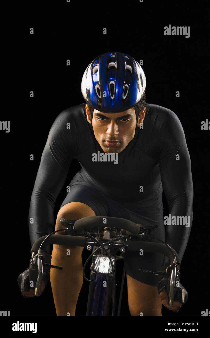 Male cyclist riding a racing bicycle Stock Photo - Alamy