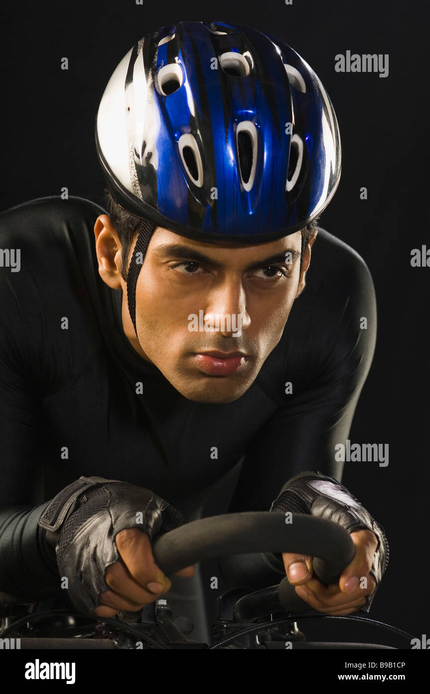 Male cyclist riding a racing bicycle Stock Photo - Alamy