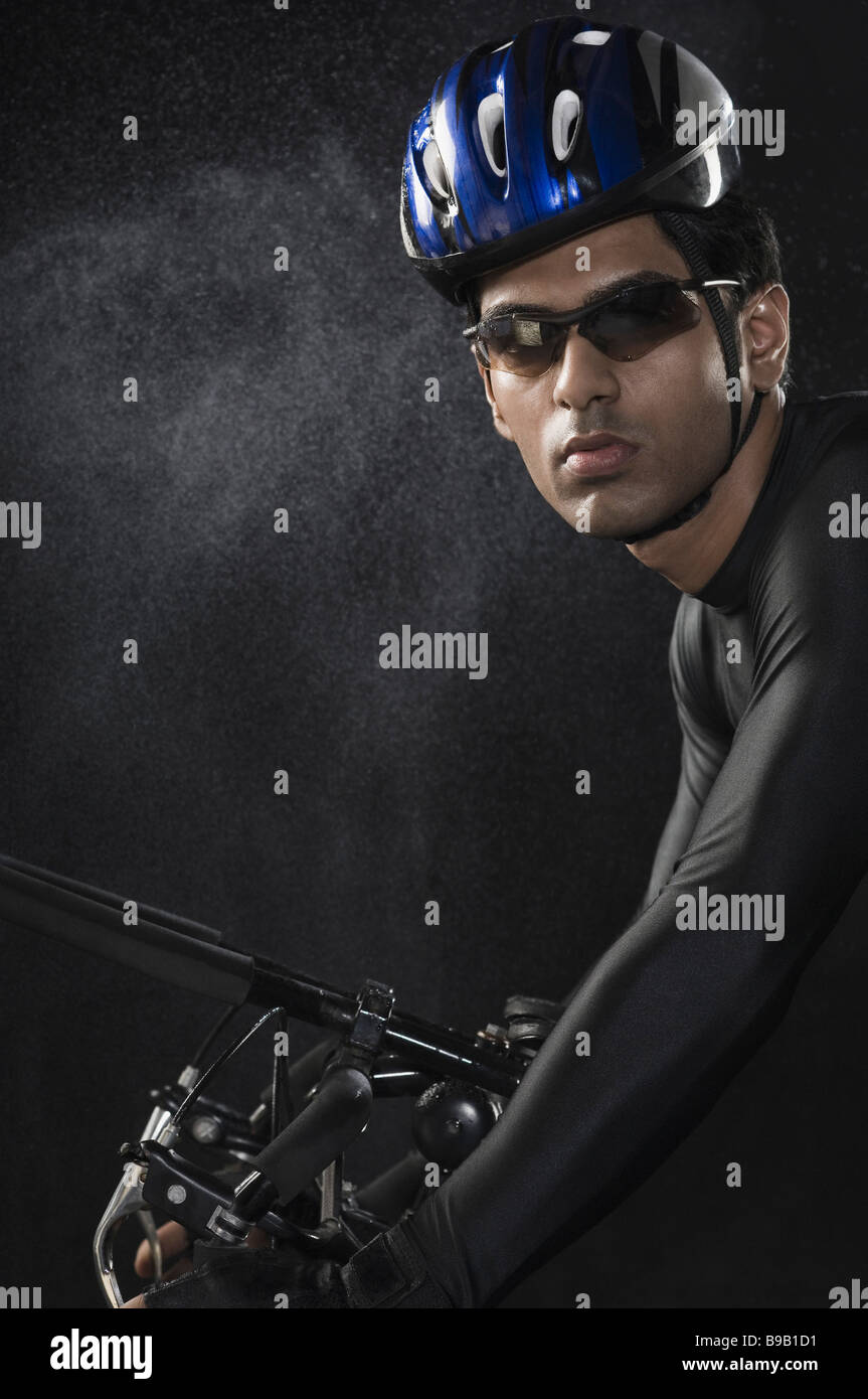 Male cyclist riding a racing bicycle Stock Photo - Alamy