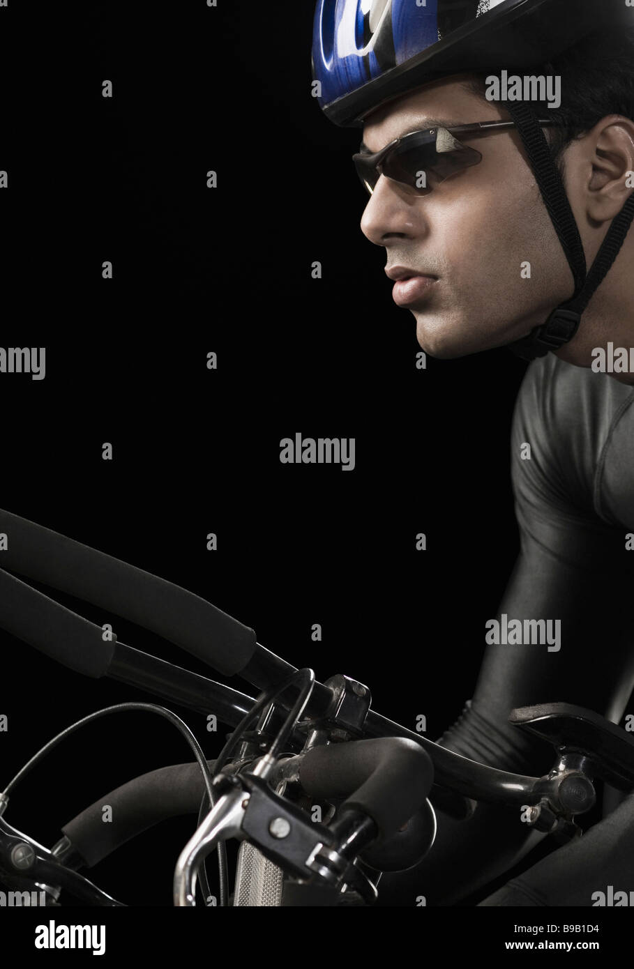 Male cyclist riding a racing bicycle Stock Photo - Alamy