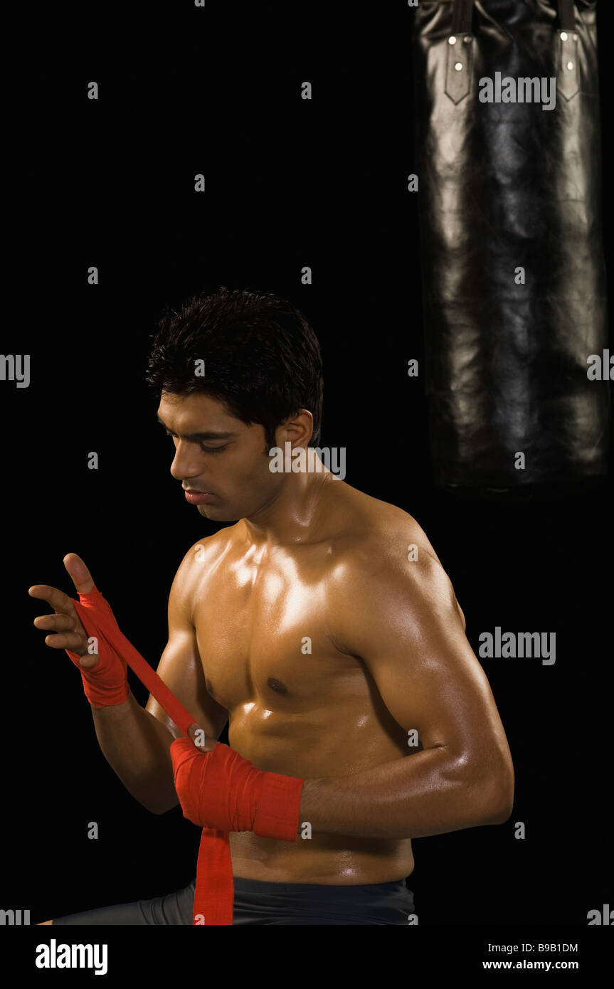 Male boxer wrapping crepe bandage on his hand Stock Photo - Alamy