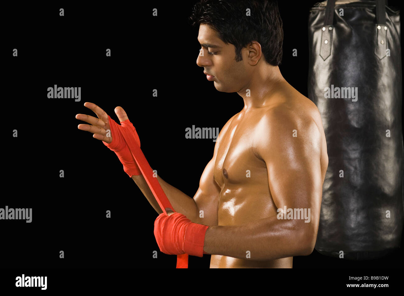 Male boxer wrapping crepe bandage on his hand Stock Photo - Alamy