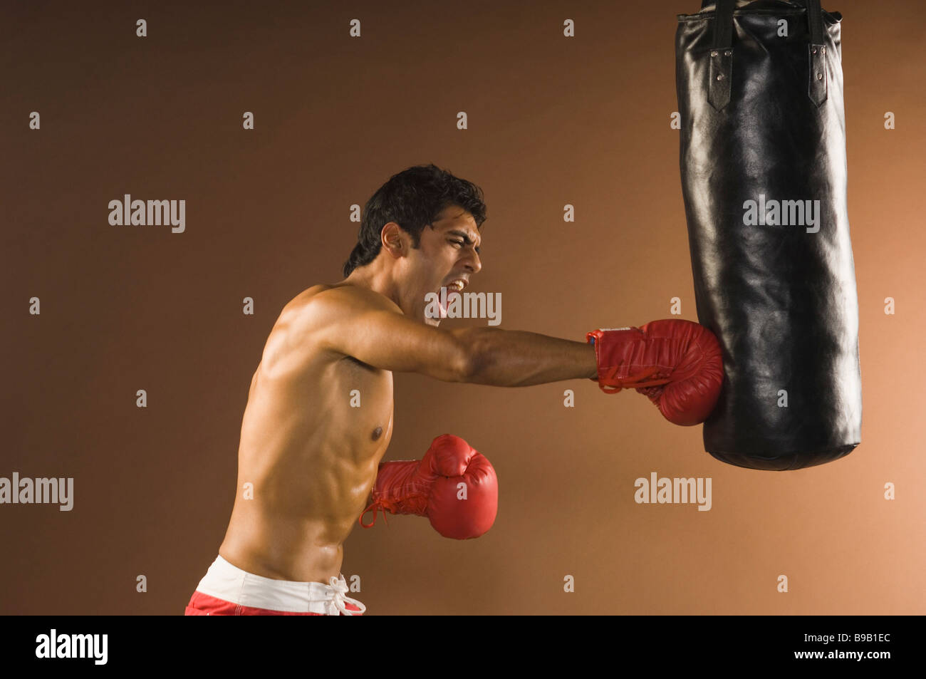 Male boxer showing aggression during practice Stock Photo - Alamy