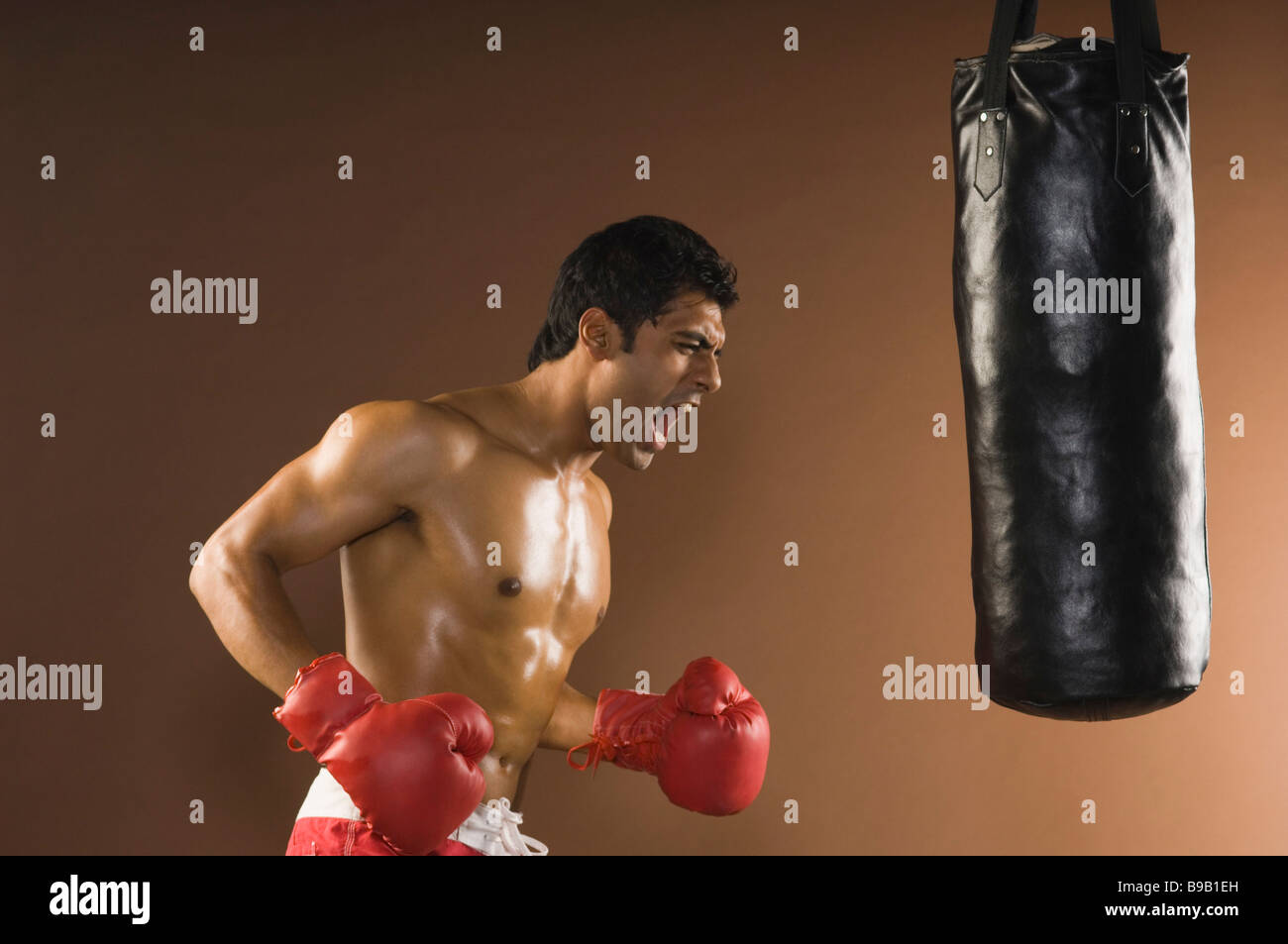 Male boxer showing aggression during practice Stock Photo - Alamy