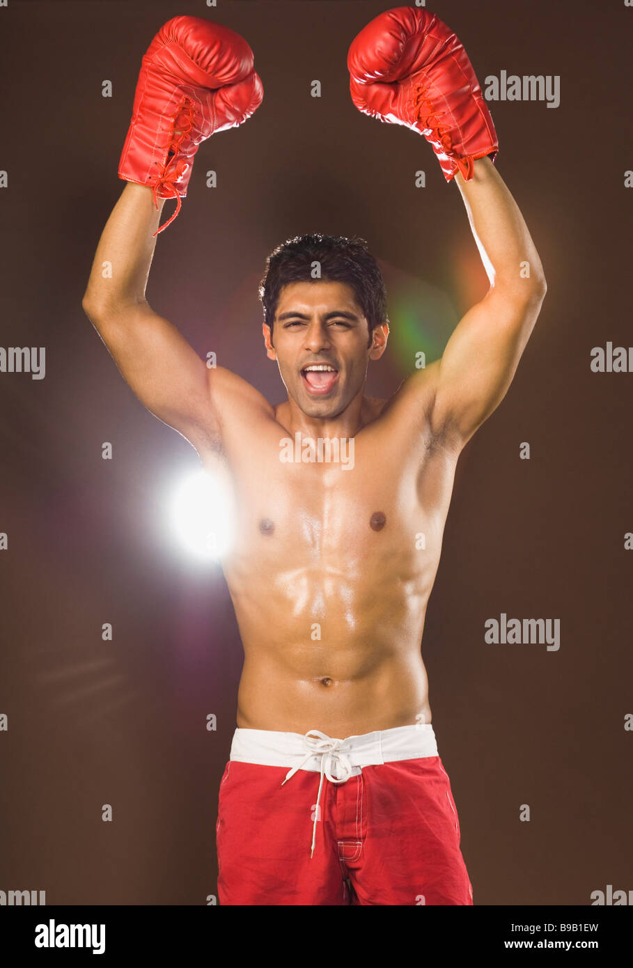 Boxer with his arms raised Stock Photo - Alamy