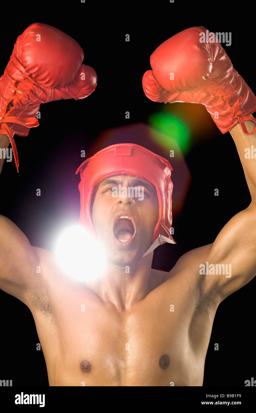 Boxer with his arms raised Stock Photo - Alamy